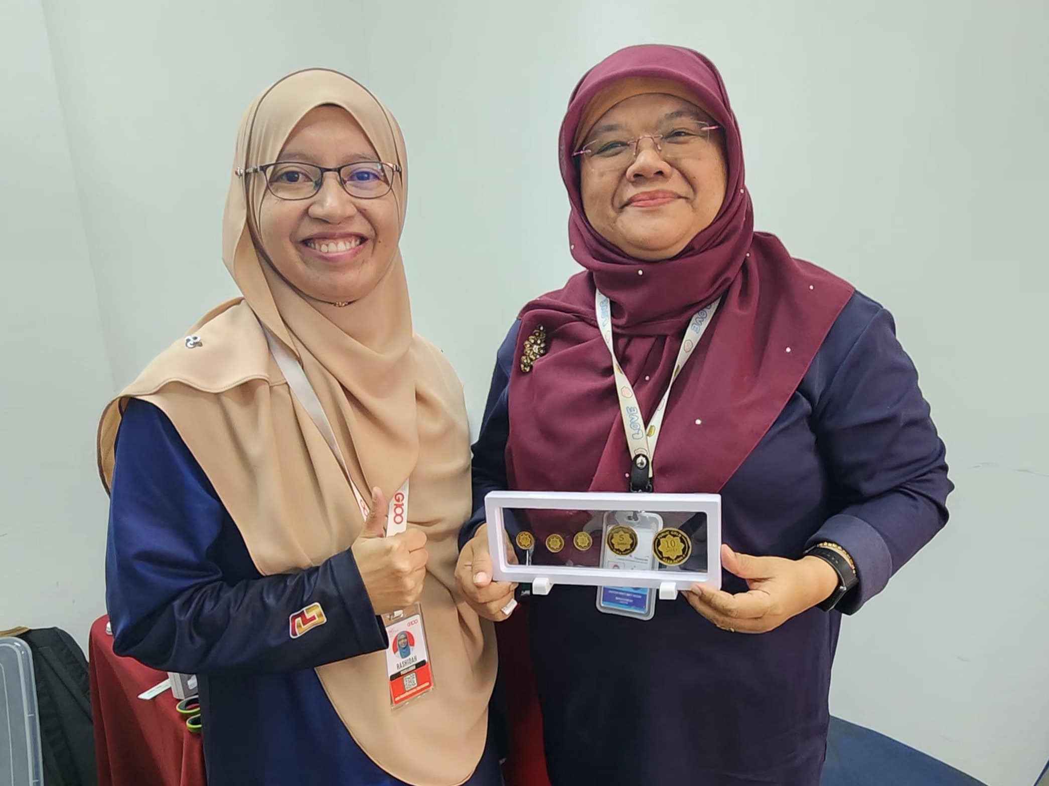 Mdm Zaiton poses for a photo holding a collection of gold dinars at the ...